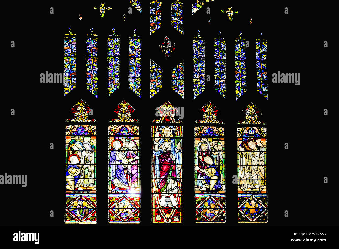 Colorful glass window with art designs in a church in dark place Stock ...