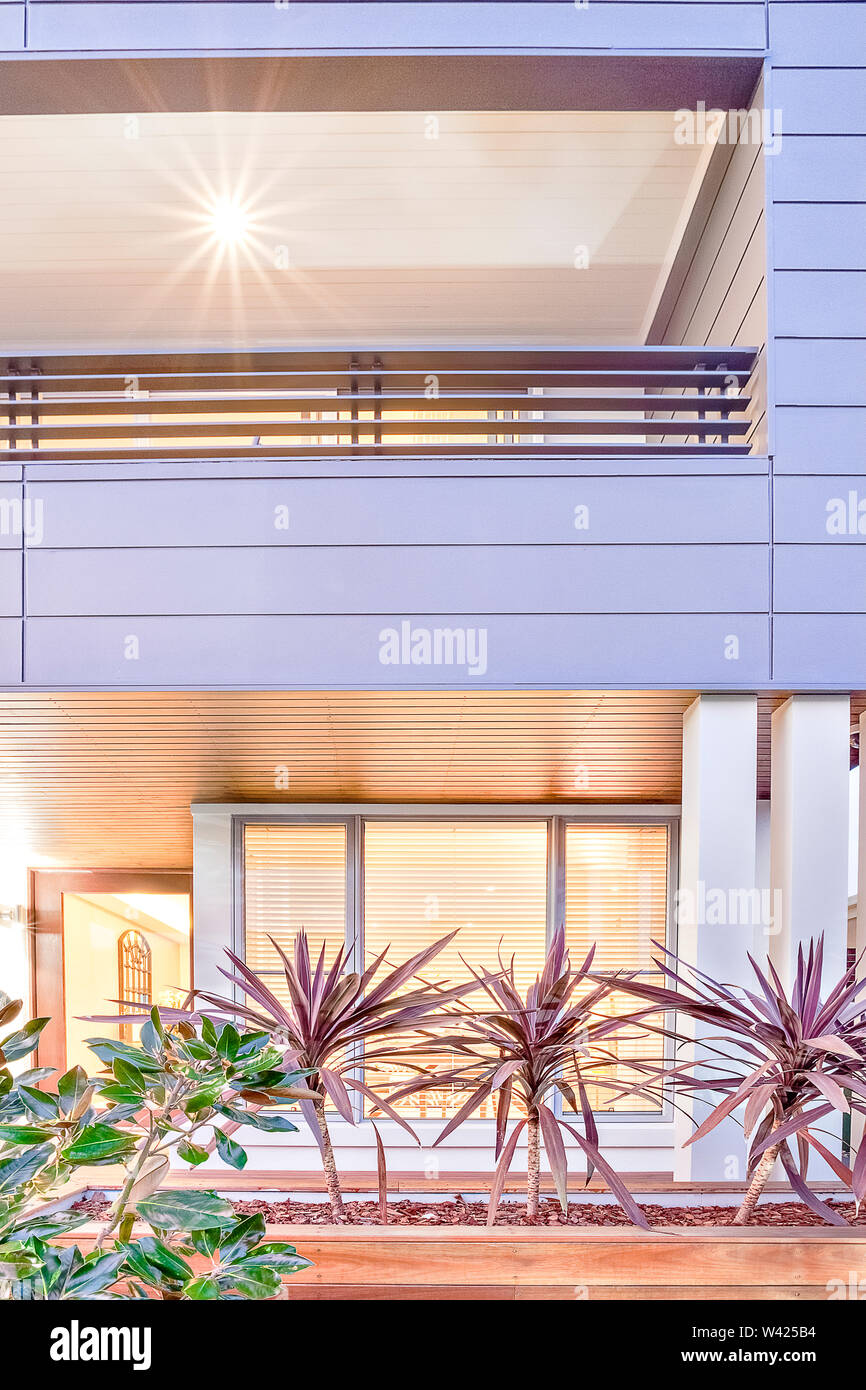 Fancy garden with modern house lights flashing close up, there is a ...