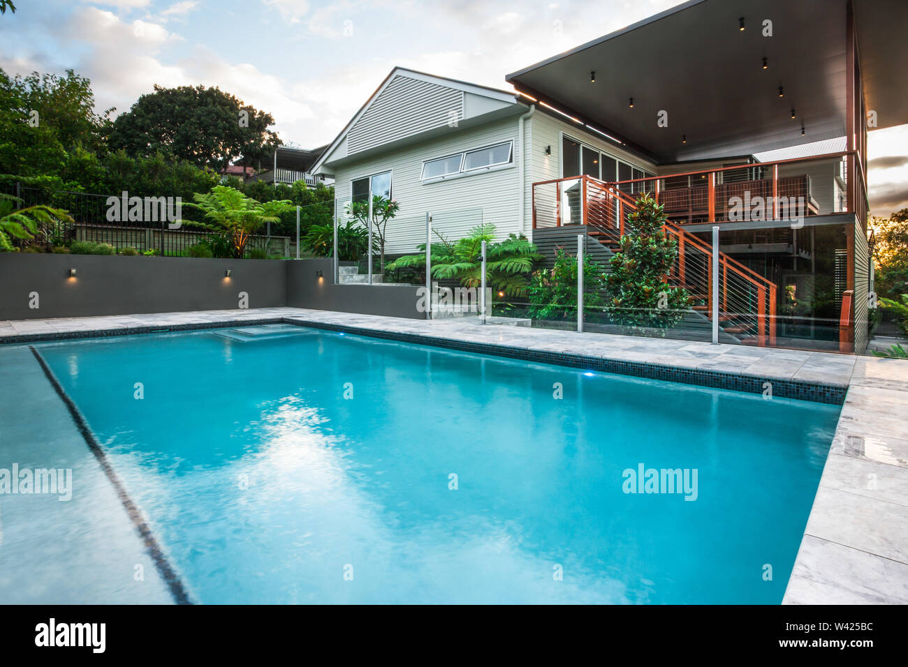 Modern pool close up with light blue water and large and beside a ...