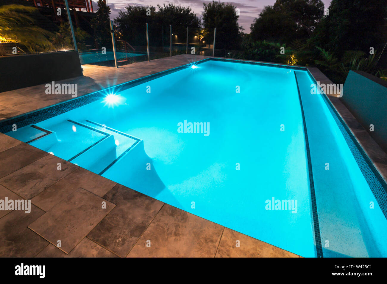 Blue water swimming pool with flashing lights with floor tiles ...