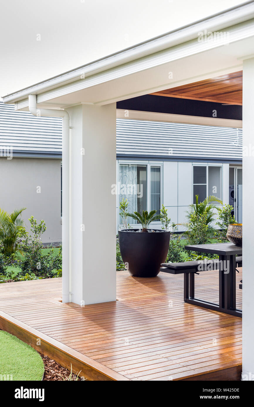 Great patio design with wood finish flooring, snack bench and a high ...