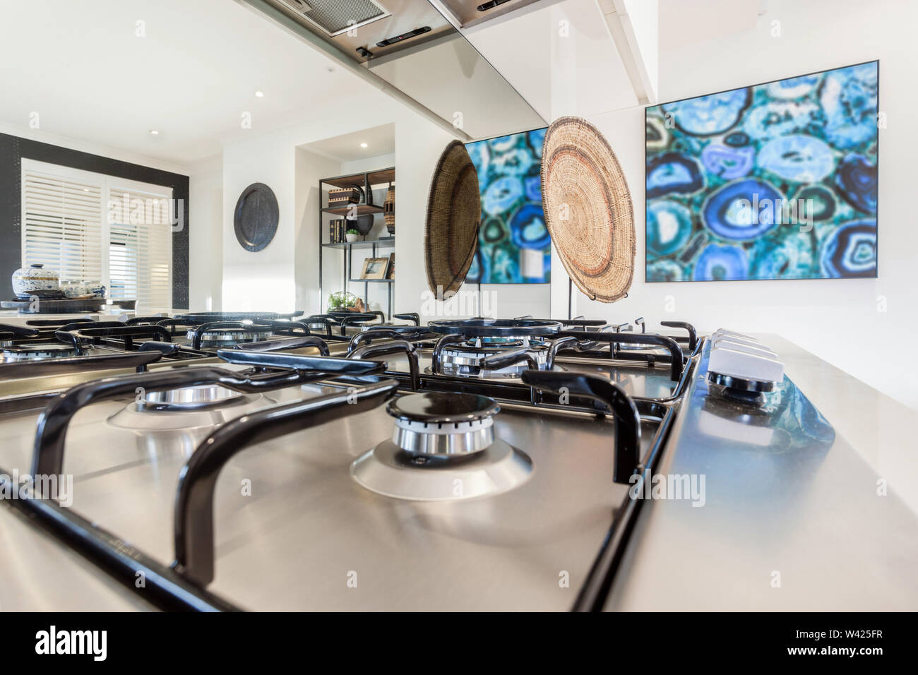 A stylish kitchen counter stove overlooking an abstract painting Stock ...