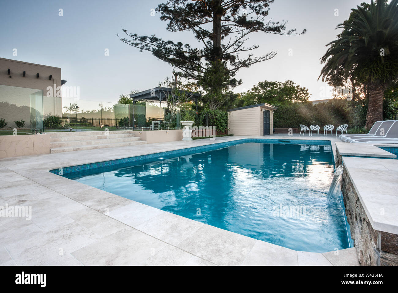 Luxury swimming pool view with blue water poolside with chairs and ...