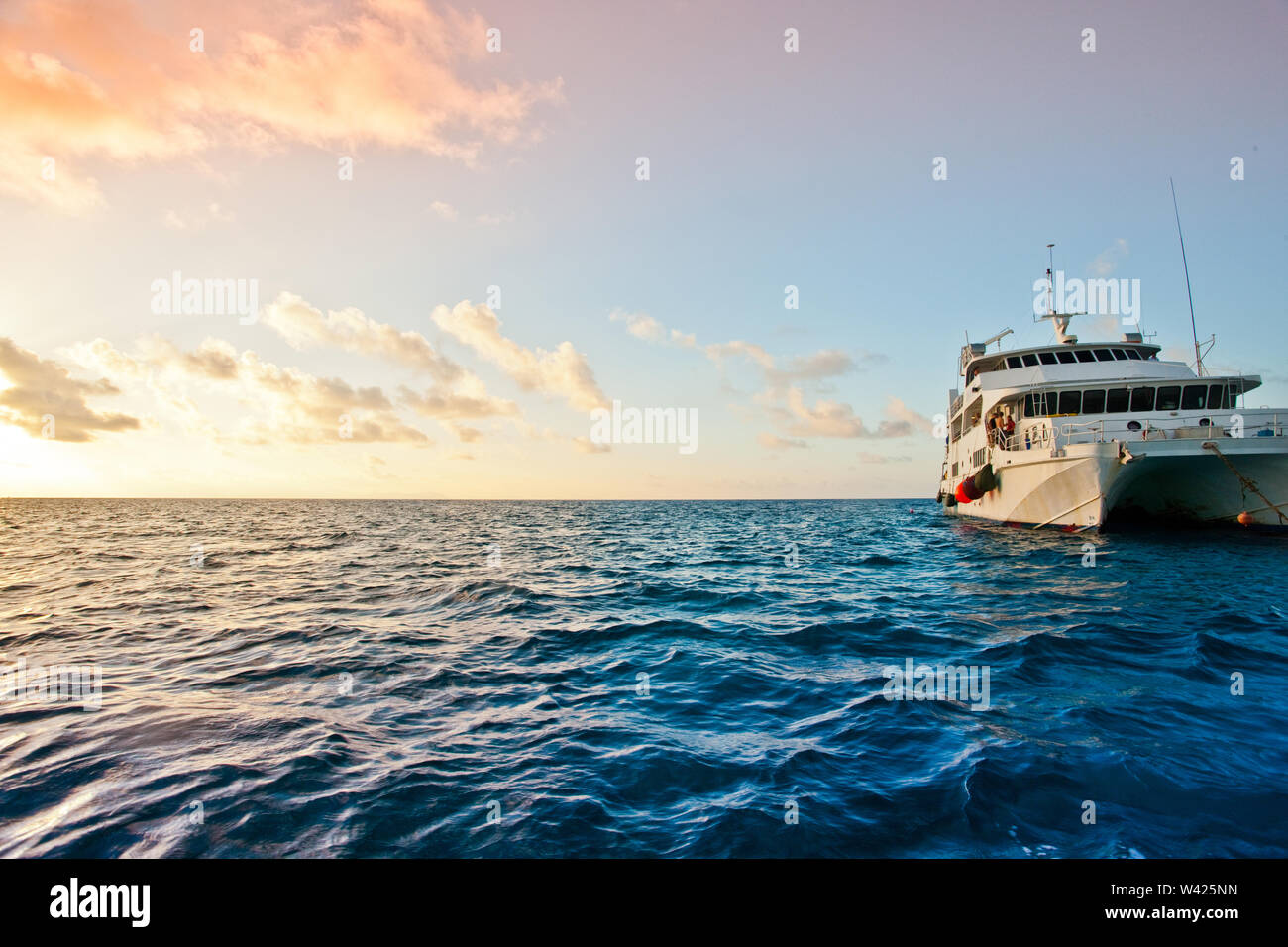 A small cruise ship sailing on the sea Stock Photo - Alamy