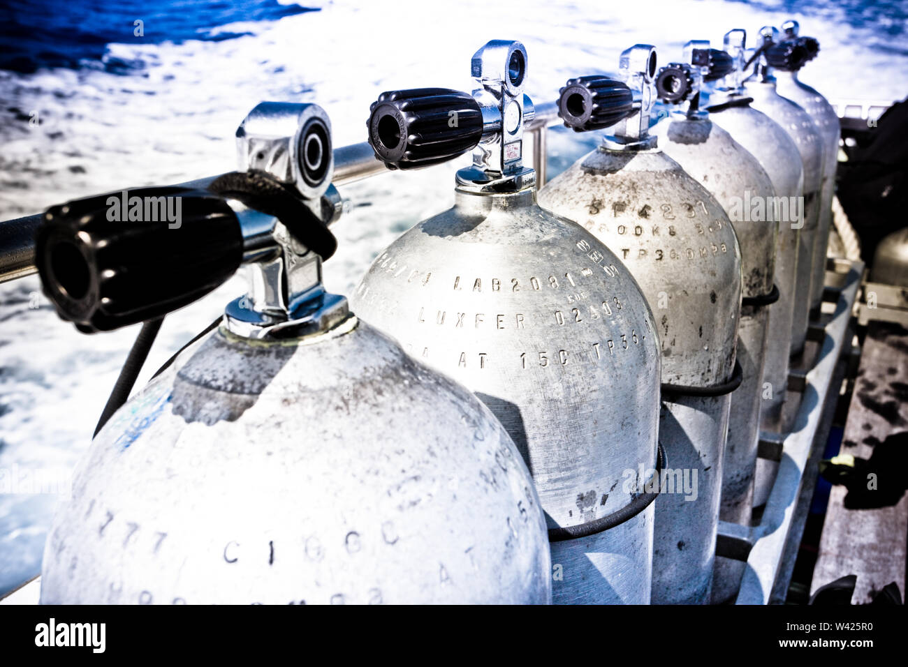 Oxygen tanks for divers lined-up on the yacht Stock Photo - Alamy