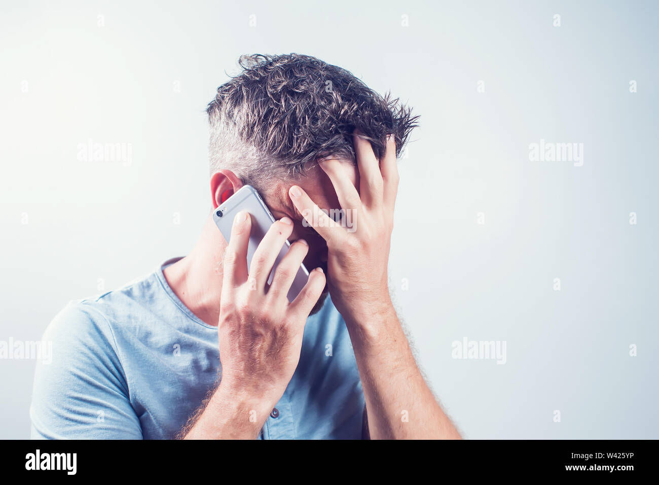 Sad man talking on smartphone hi-res stock photography and images - Alamy