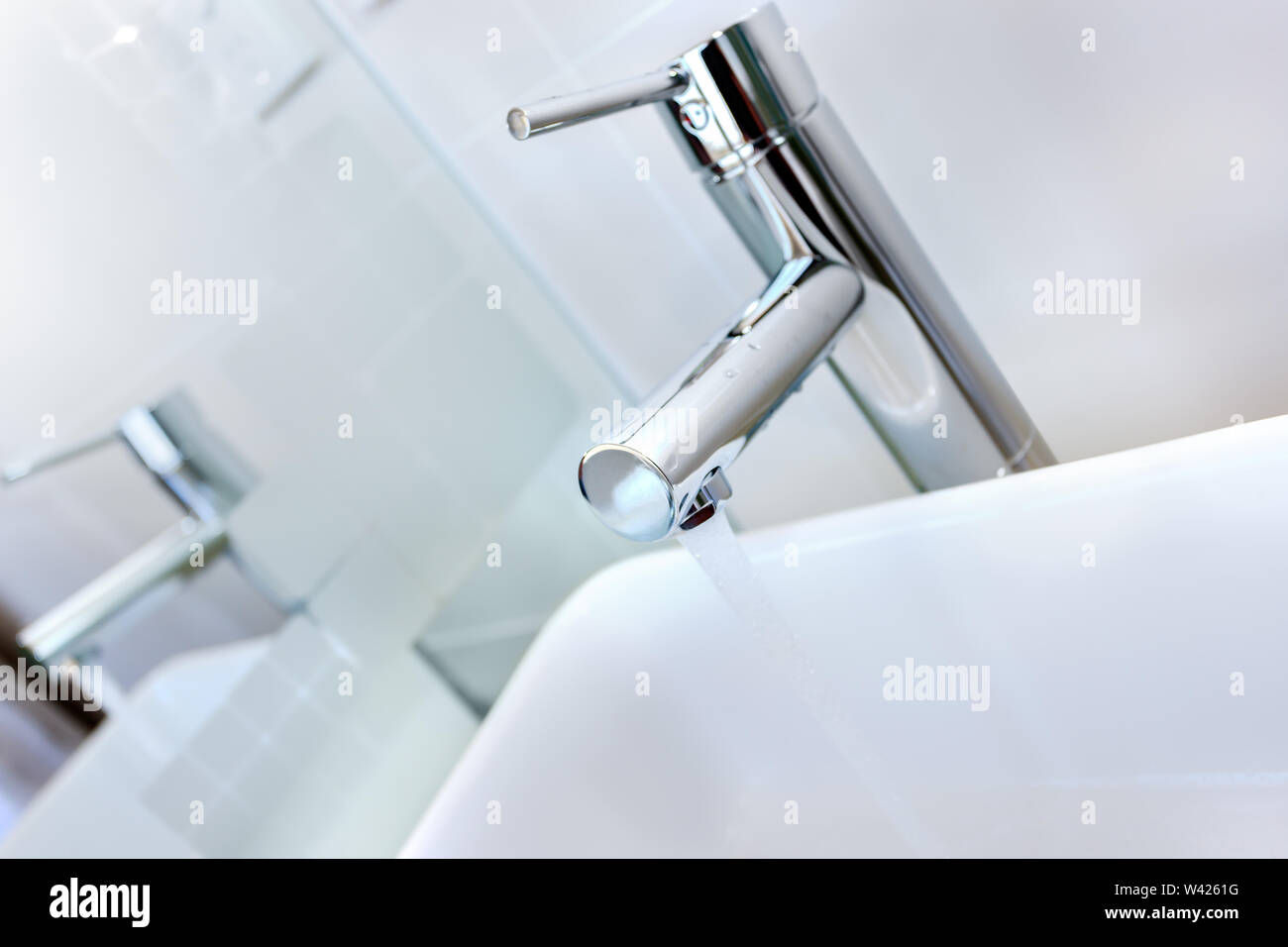 Closeup image of a popular modern bathroom faucet is made by silver ...