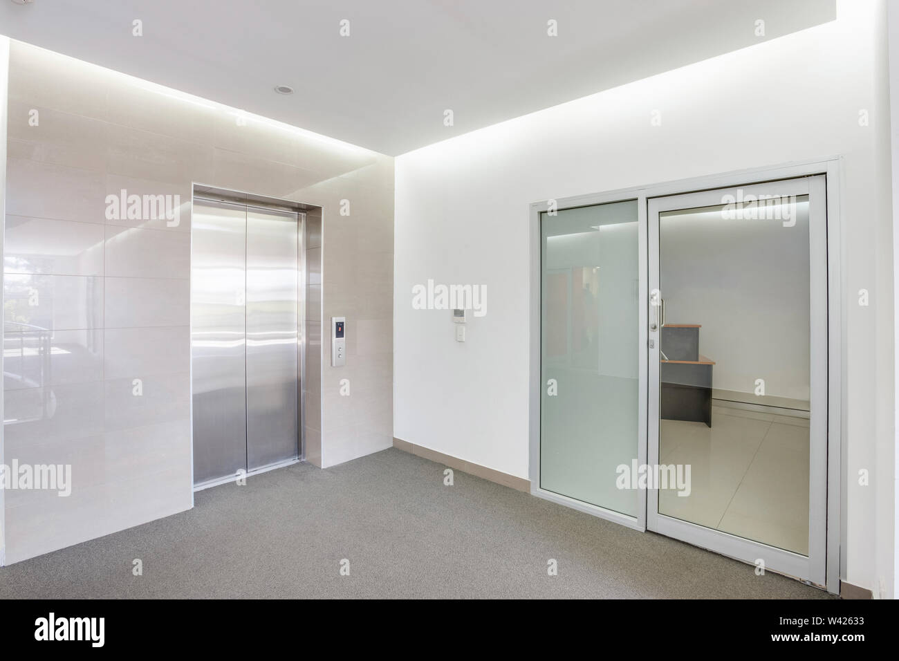 A corridor outside the room with stylish sliding glass doors adjacent ...