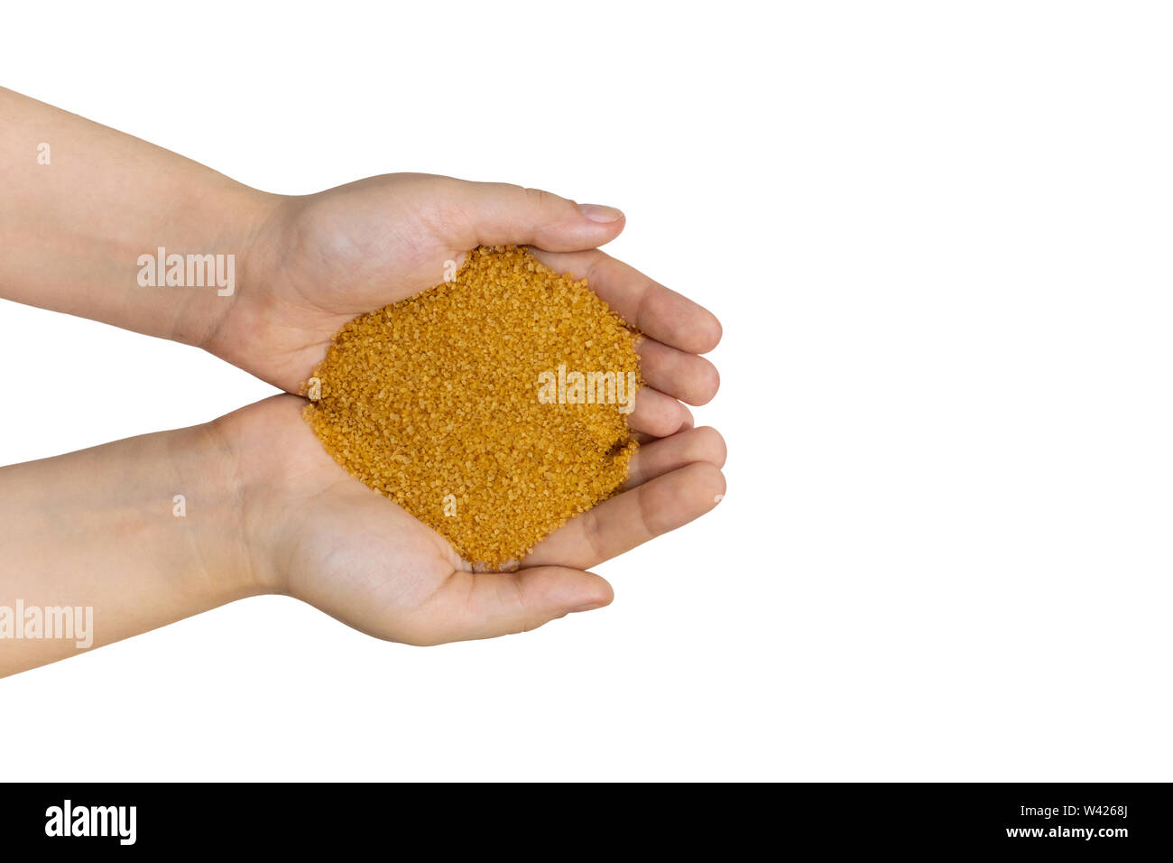 Brown sugar in female hands, isolated, close up, macro, top view ...