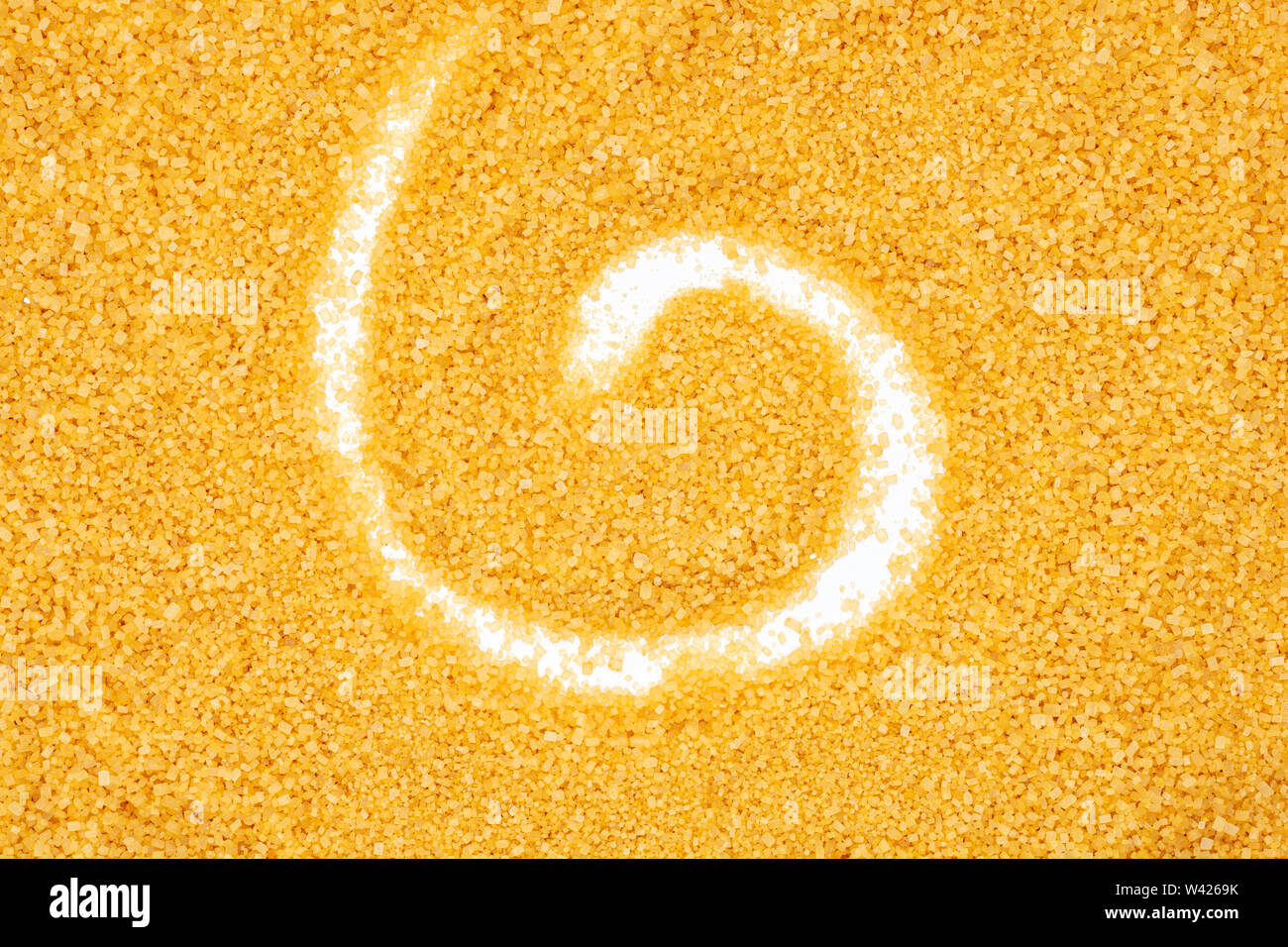 Brown sugar, spiral shape, close up, macro, top view. Popular sweetener ...