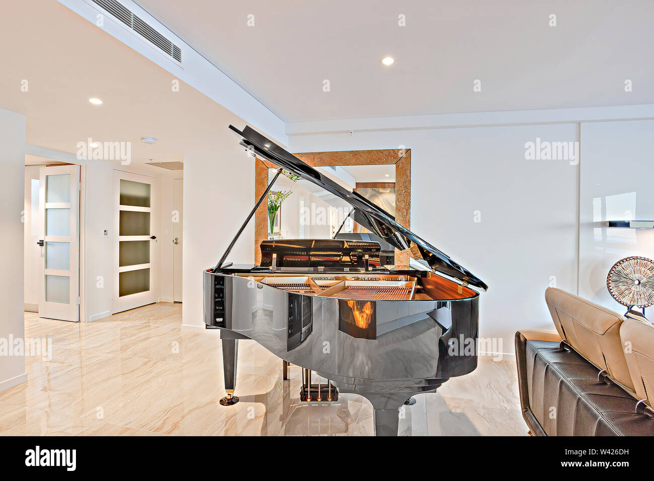 A grand piano with a mirror at the background Stock Photo - Alamy