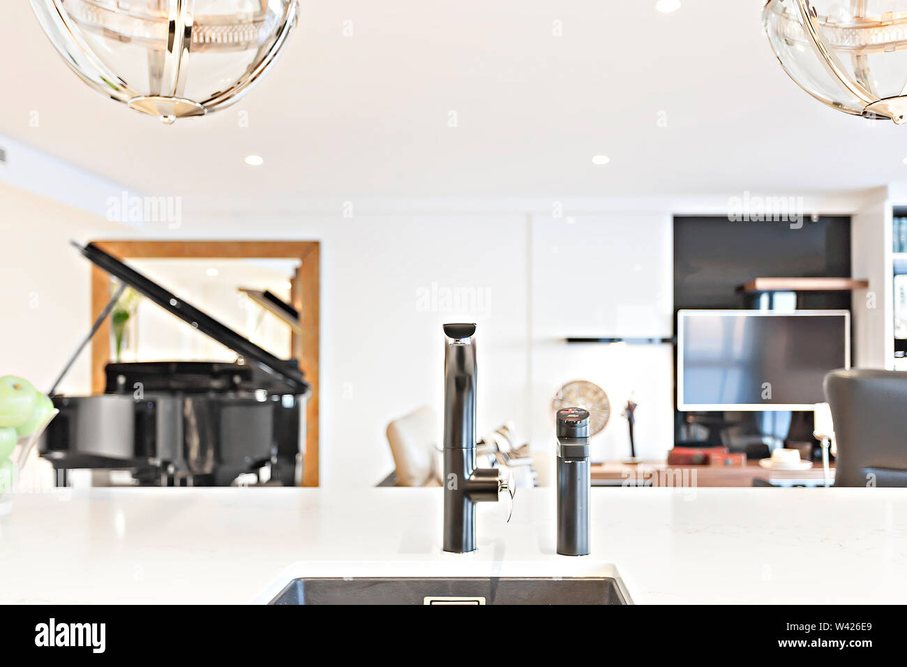 Artsy basin taps in matte black on the kitchen counter Stock Photo - Alamy