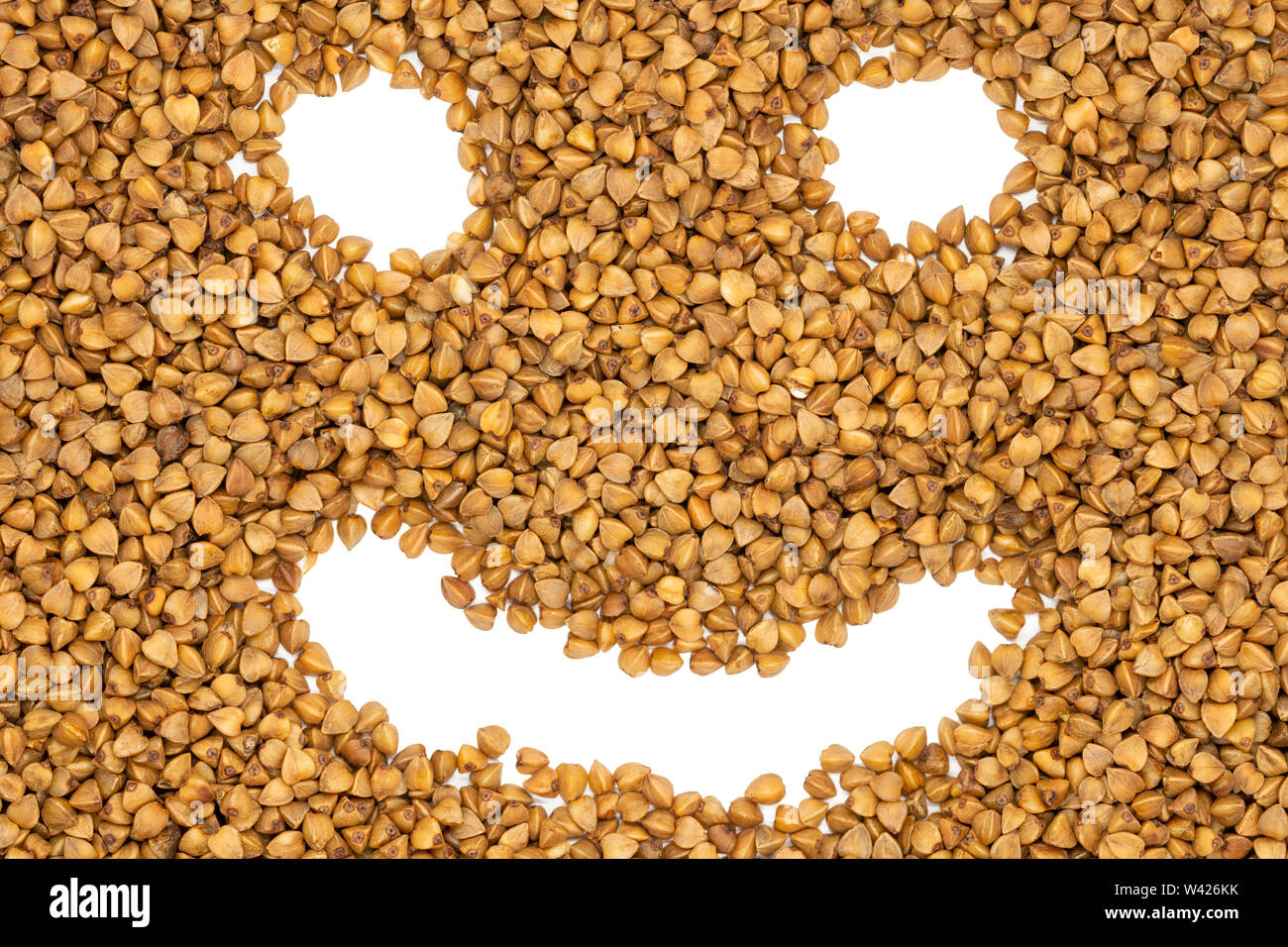 Buckwheat groats, funny smile face, close up. Gluten free and non ...