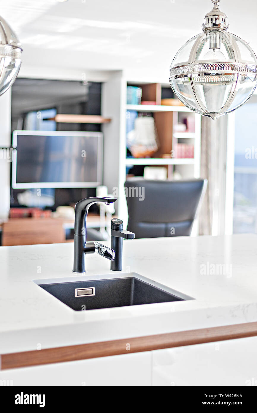 A minimalist counter-top basin with hanging pendant lights Stock Photo ...