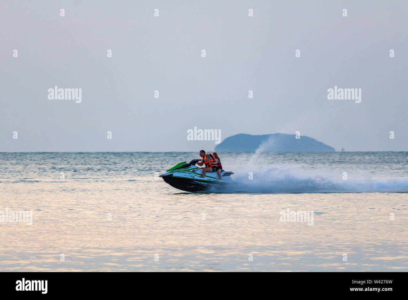 Koh Samui, Thailand - April 17, 2019: Couple riding a jet ski at sunset ...