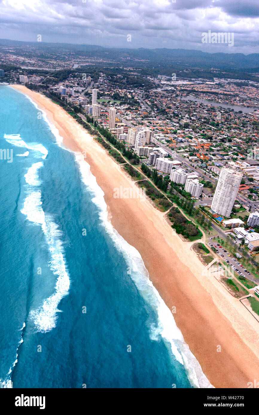 Long beach stretching in front of a huge modern city, surfers paradise ...