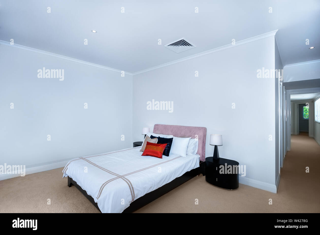 A bedroom with a double bed without a door, connected to a hallway ...