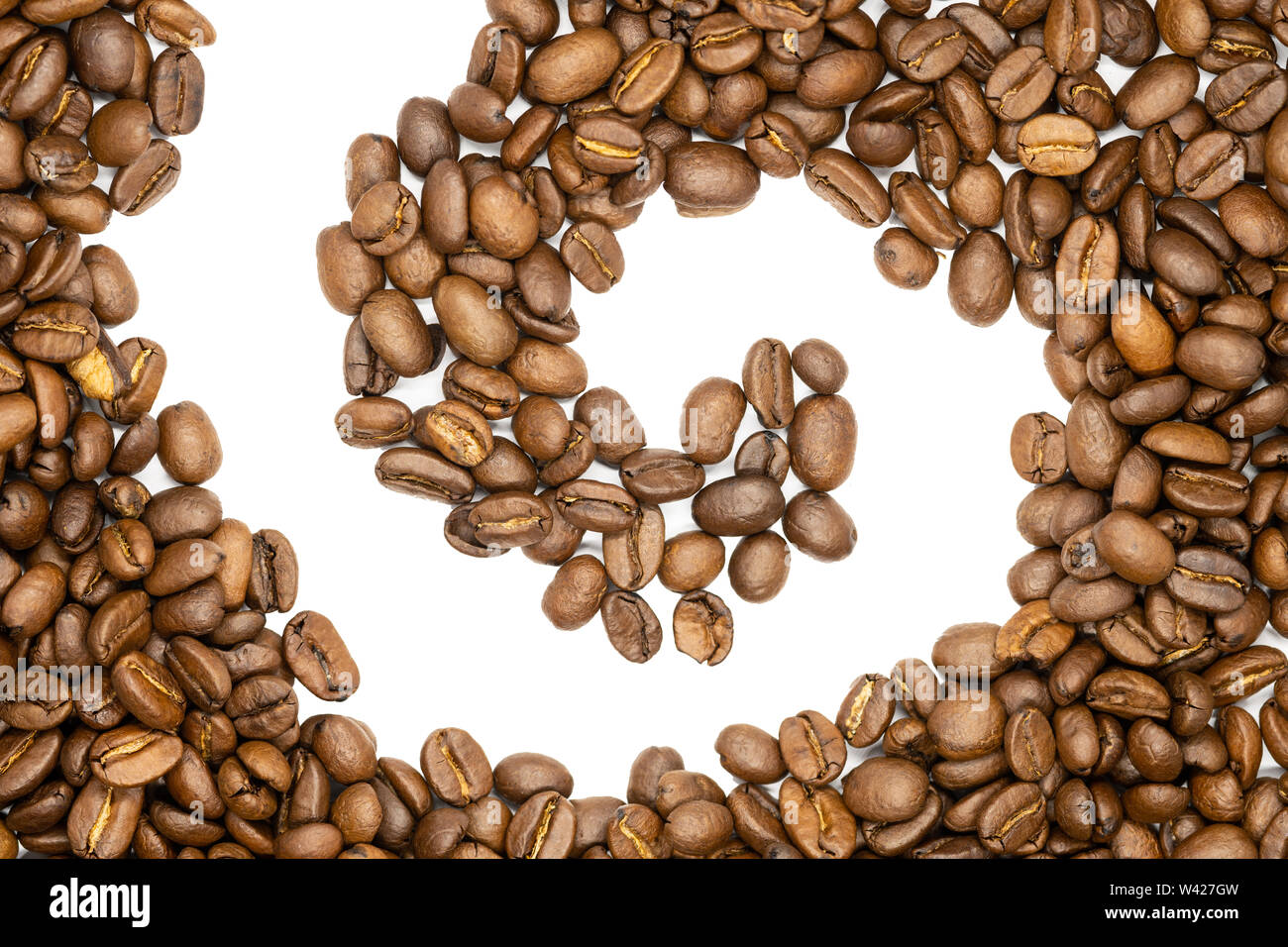 Roasted coffee beans, spiral shape, close up. Delicious raw Indian ...