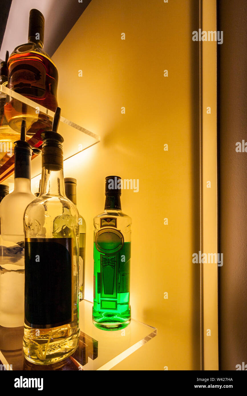 Wine bottles on shop rackes, inside of luxury club area, night time ...