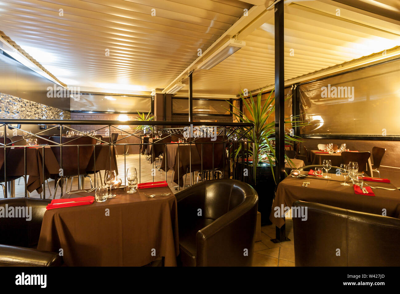 Small glasses with spoons on modern tables, inside of luxury club area ...