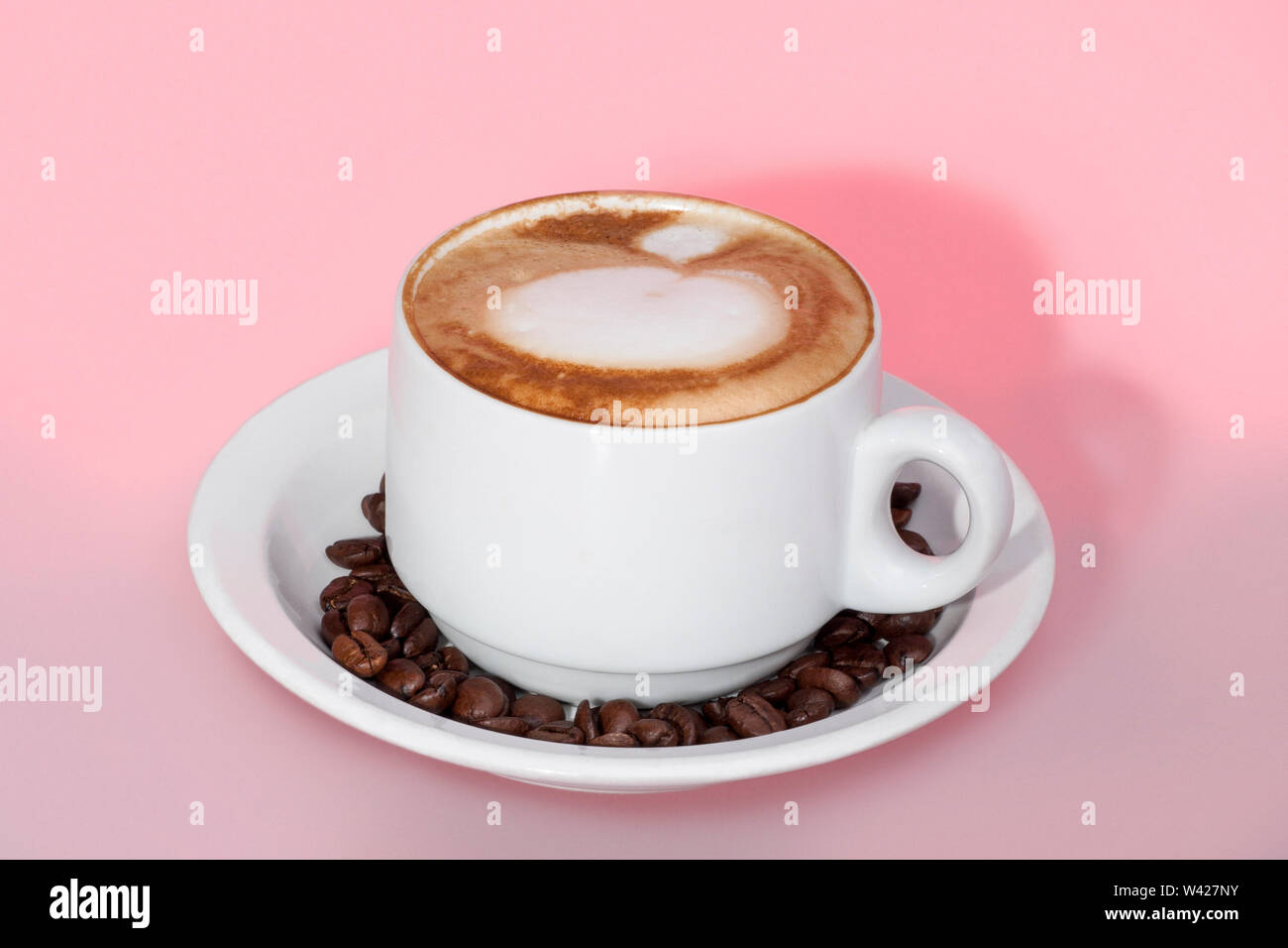 Natural milk coffee with design, white color cup and background ...