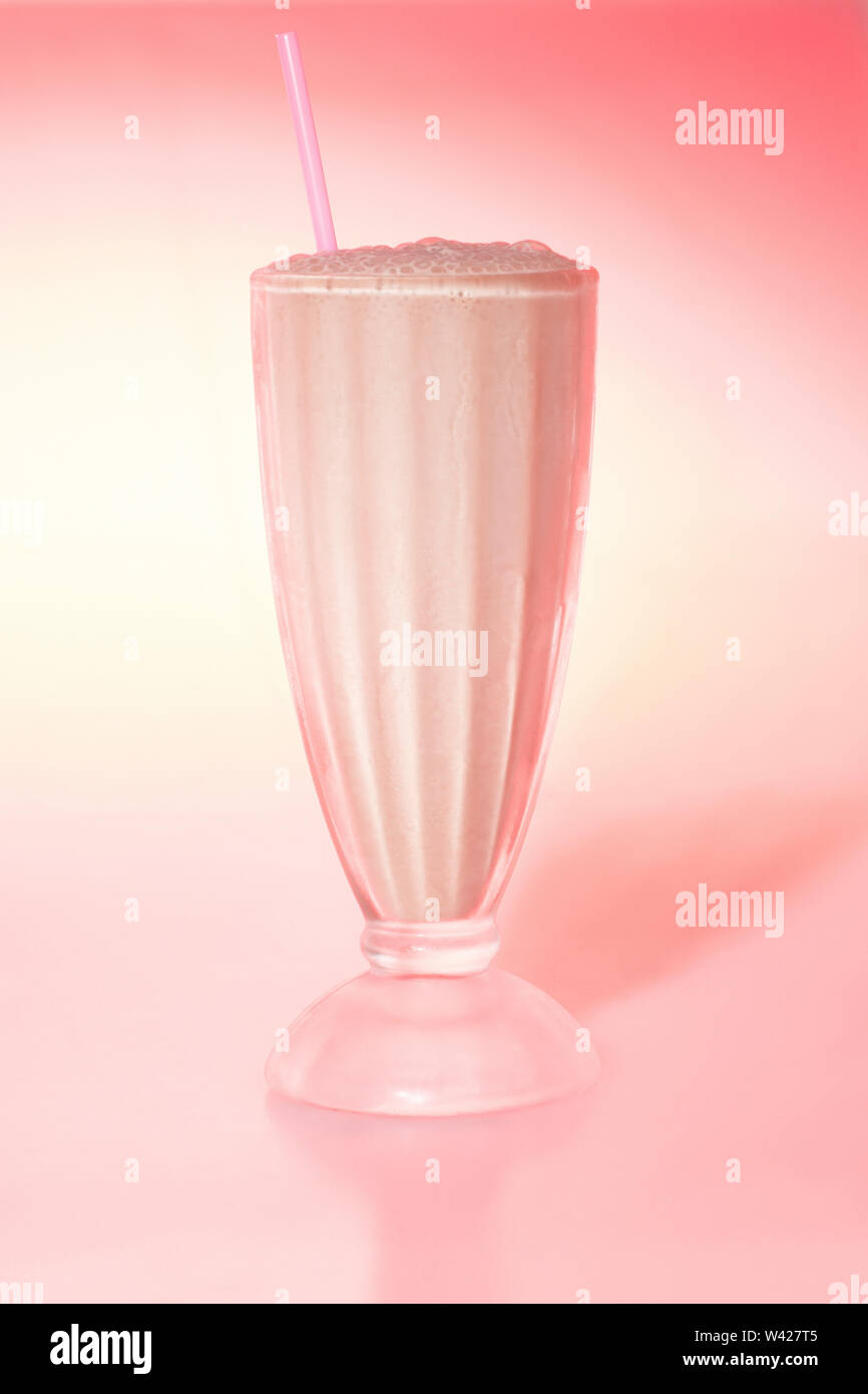 Expensive juice with vegetables in glass, pink color cup and background ...