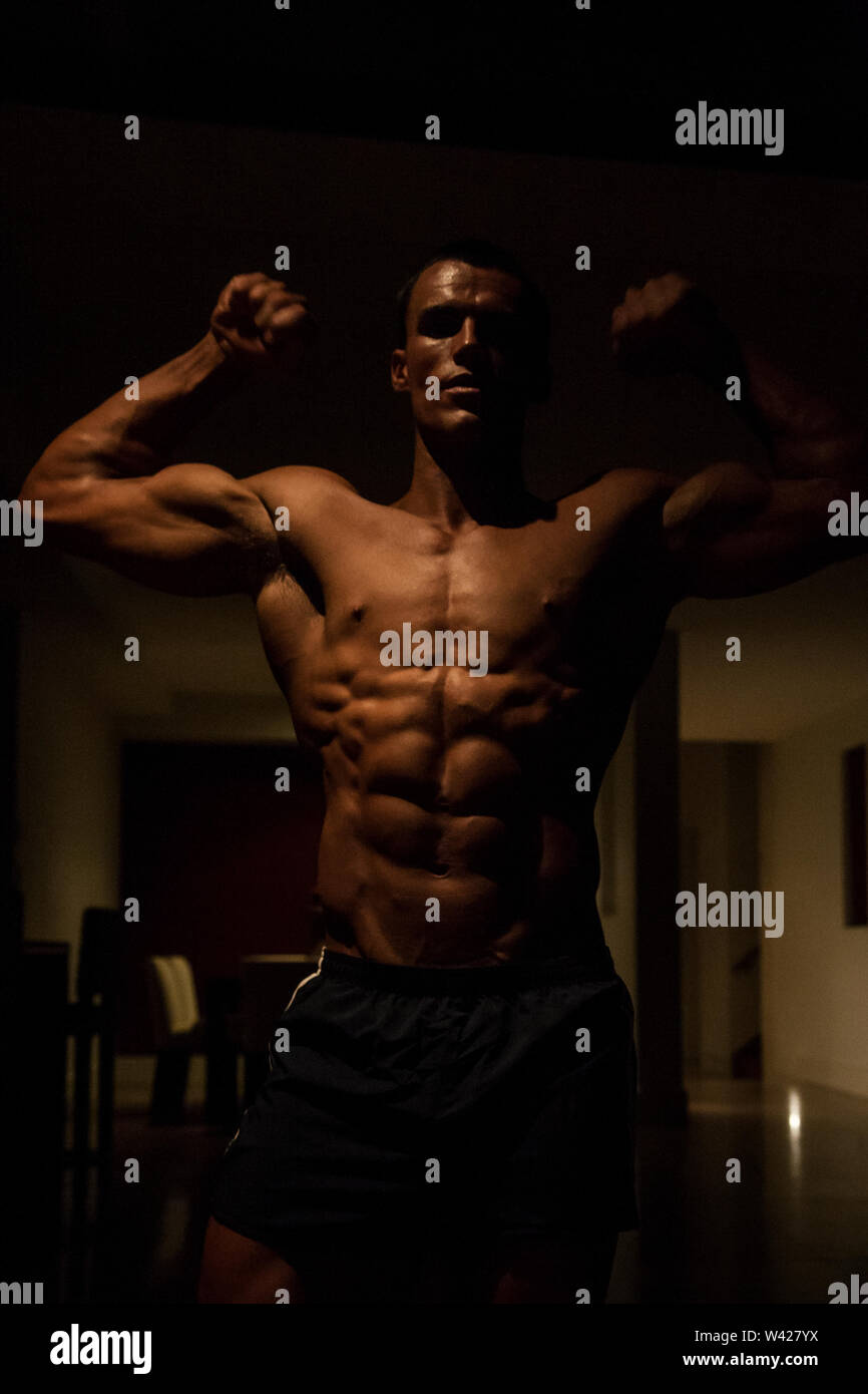 Man with strong and tired look, night time scene at inside room of a ...