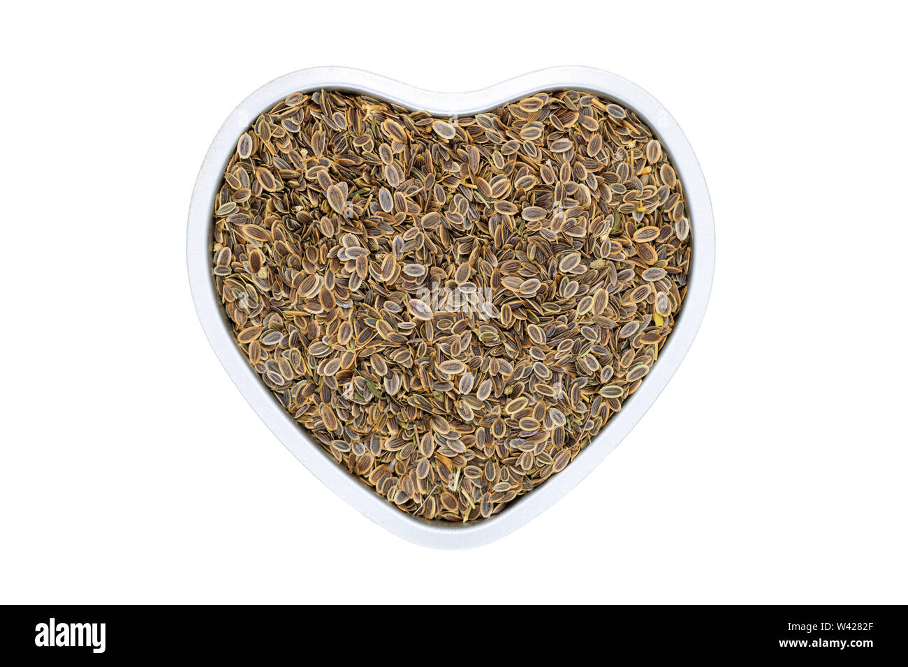 Dill seeds, heart-shaped, close up, isolated. Annual fennel herb used ...