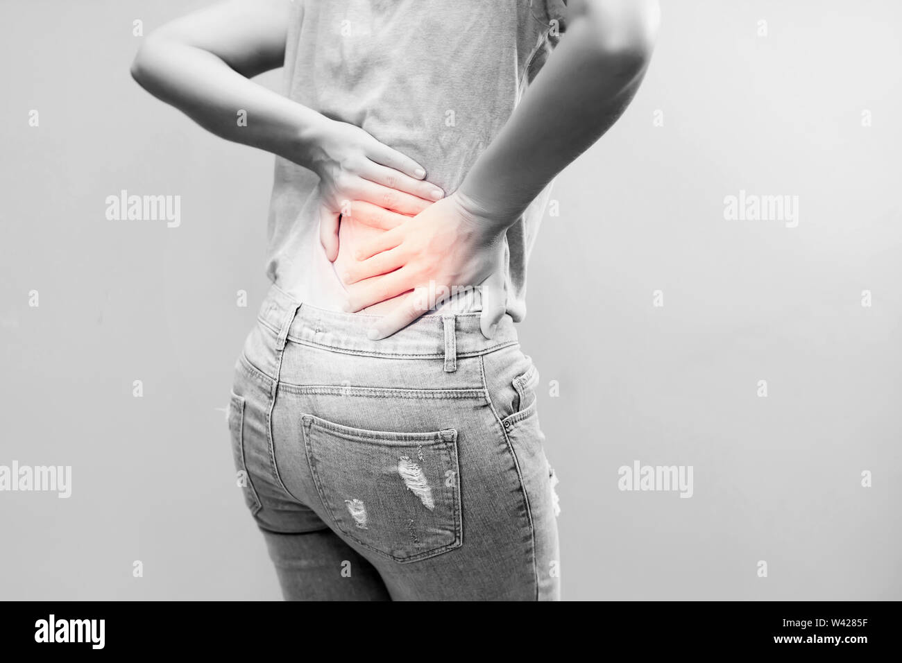 Woman touching her back hi-res stock photography and images - Alamy