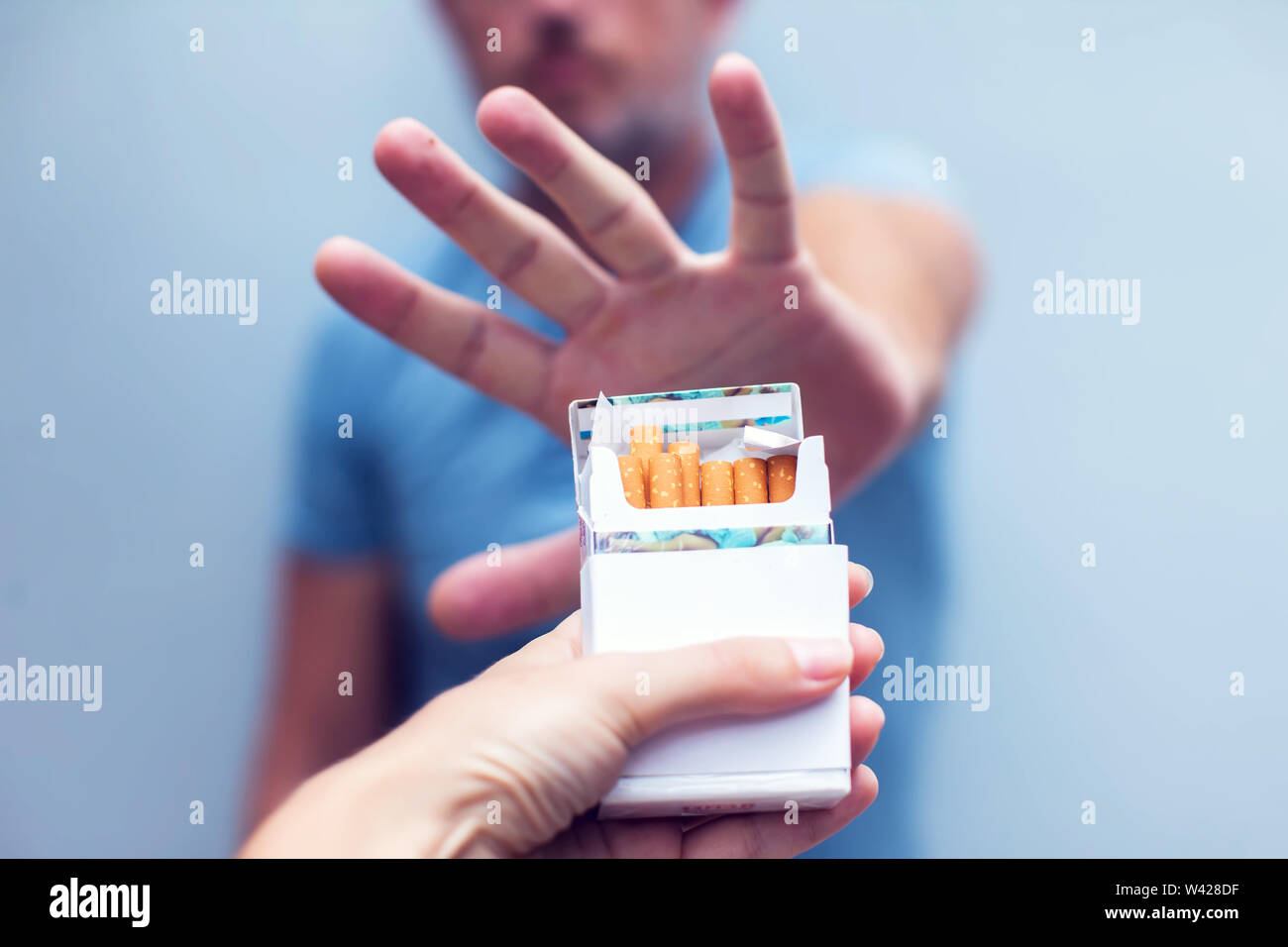 Man refusing a cigarette from a pack of smokes concept for quitting ...