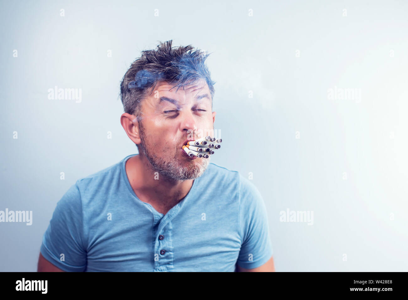Young men smoking cigarettes in hi-res stock photography and images - Alamy