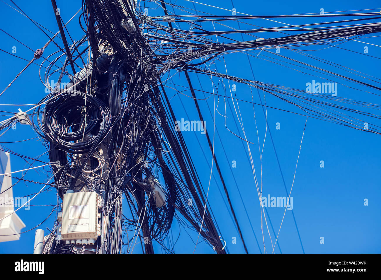 Messy electric wiring on the pole Stock Photo - Alamy