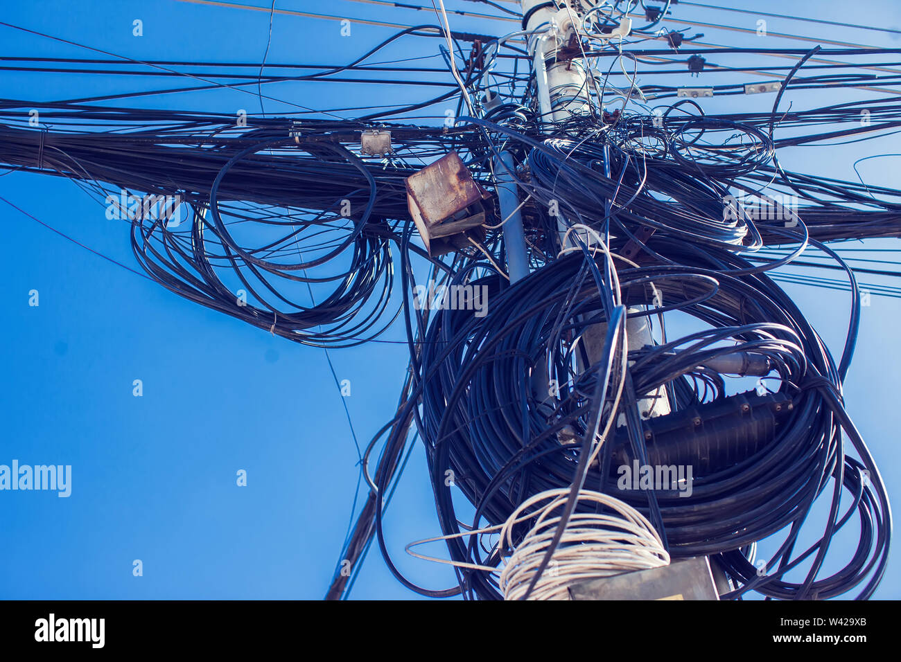 Messy electric wiring on the pole Stock Photo - Alamy