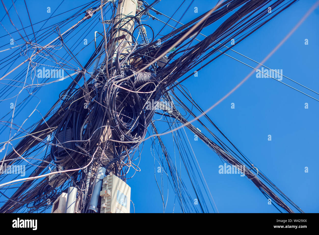 Messy electric wiring on the pole Stock Photo - Alamy