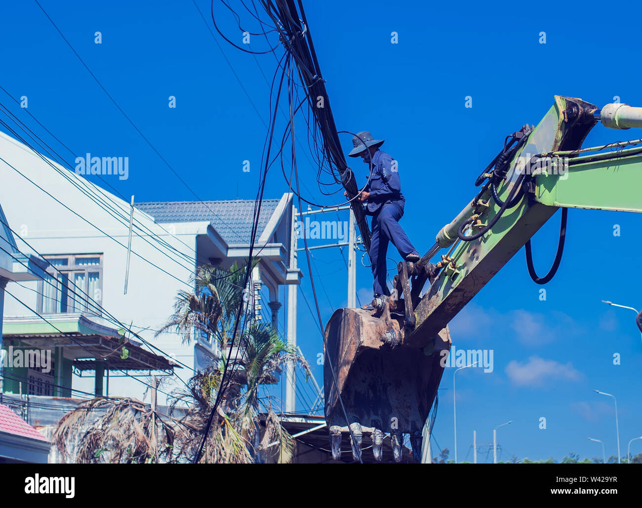 Electrician lineman repairman worker at climbing work on electric post ...