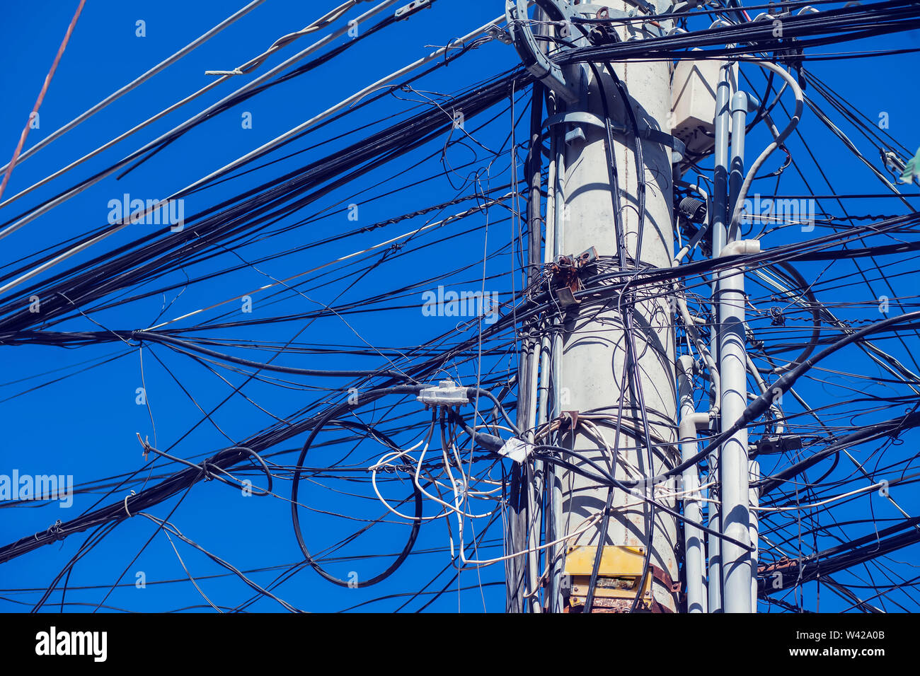 Messy electric wiring on the pole Stock Photo - Alamy