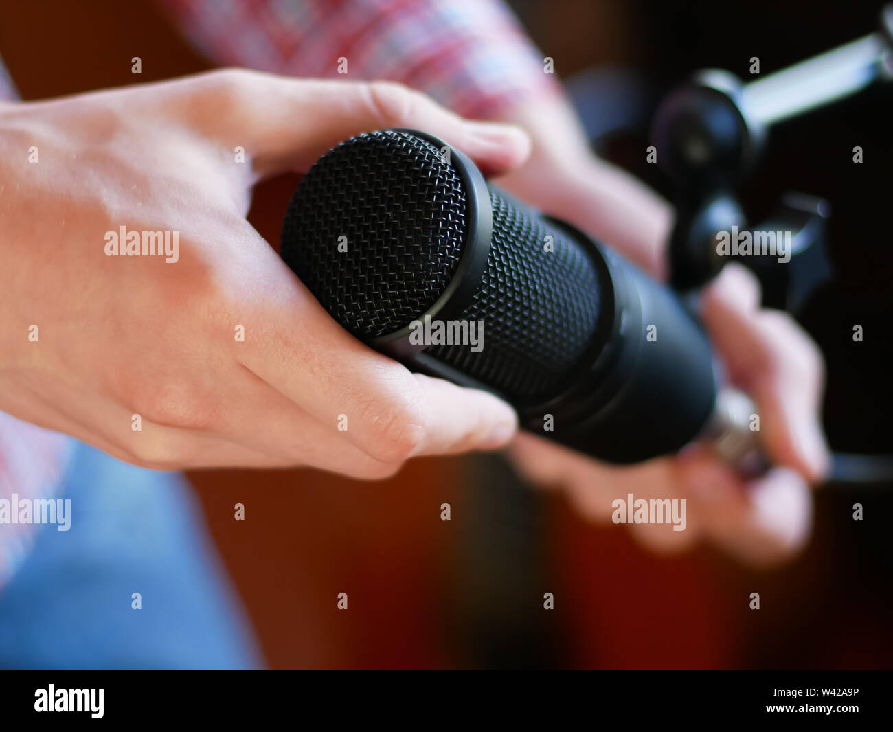 hand holding the studio microphone, musical set up. concert preparation ...