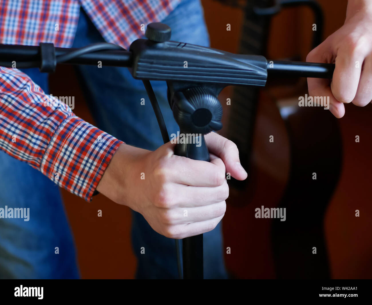 hand holding the studio microphone stand, musical set up. concert ...