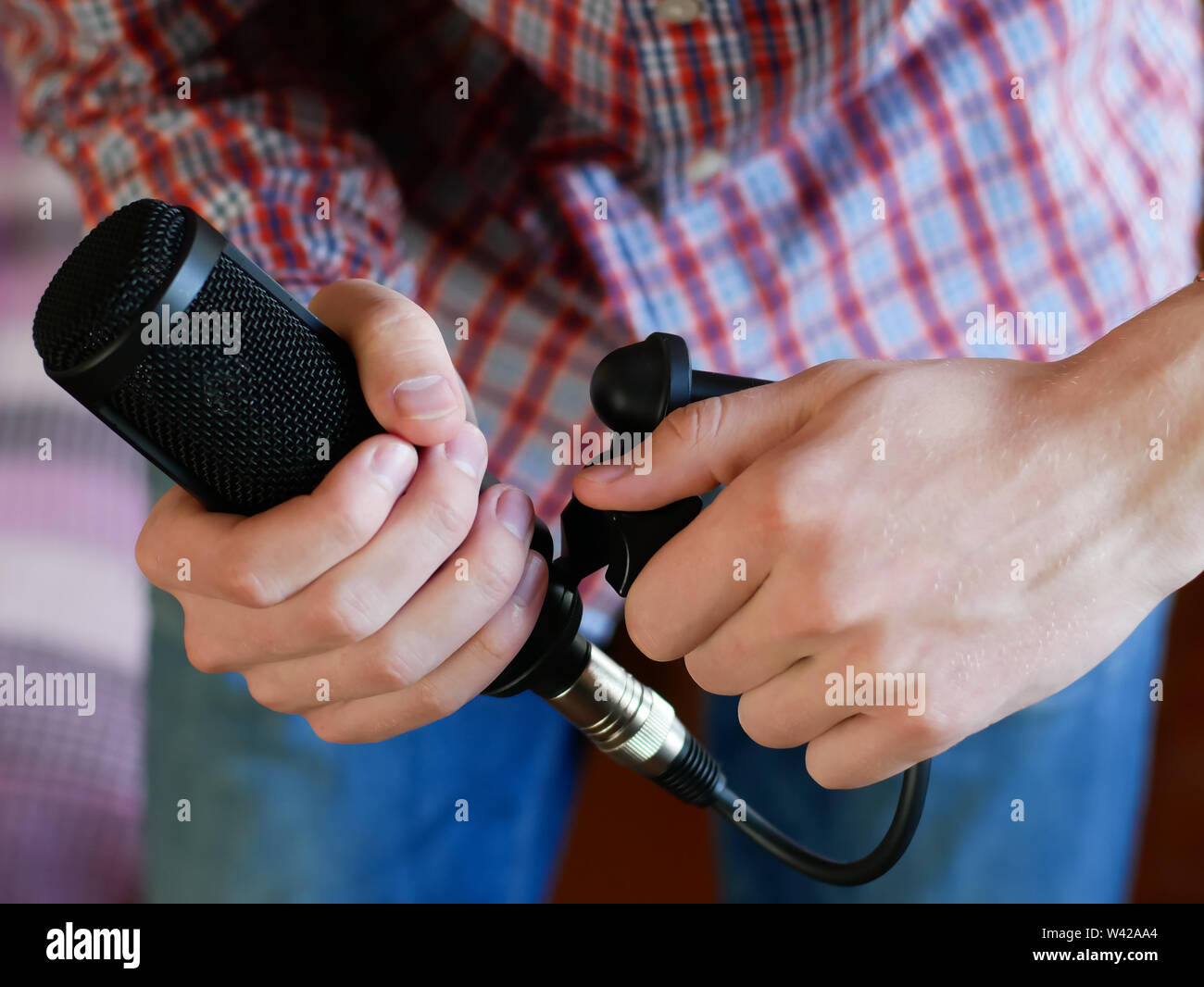 hand holding the studio microphone, musical set up. concert preparation ...