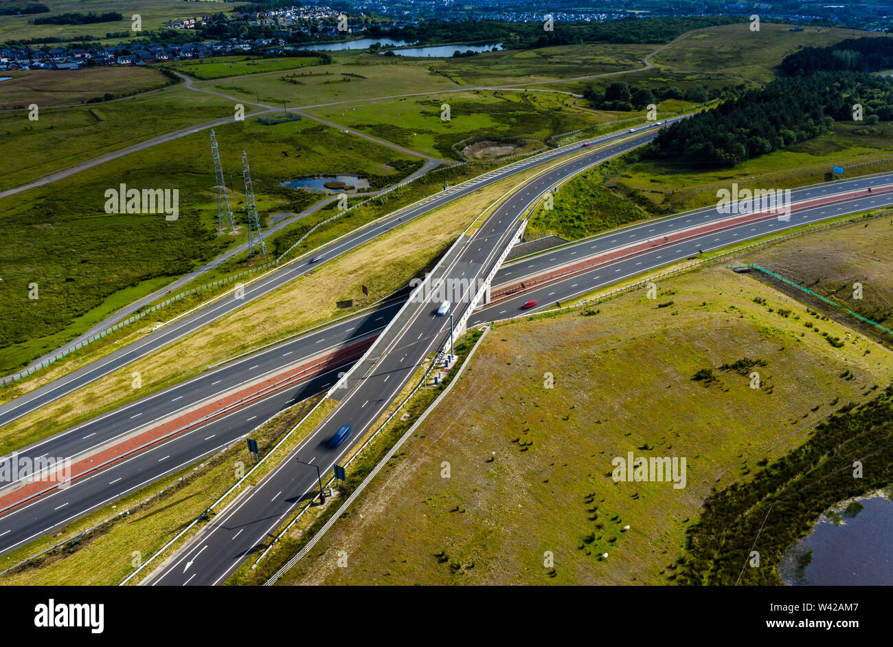 Aerial drone view of a large, new dual carriageway road with motion ...