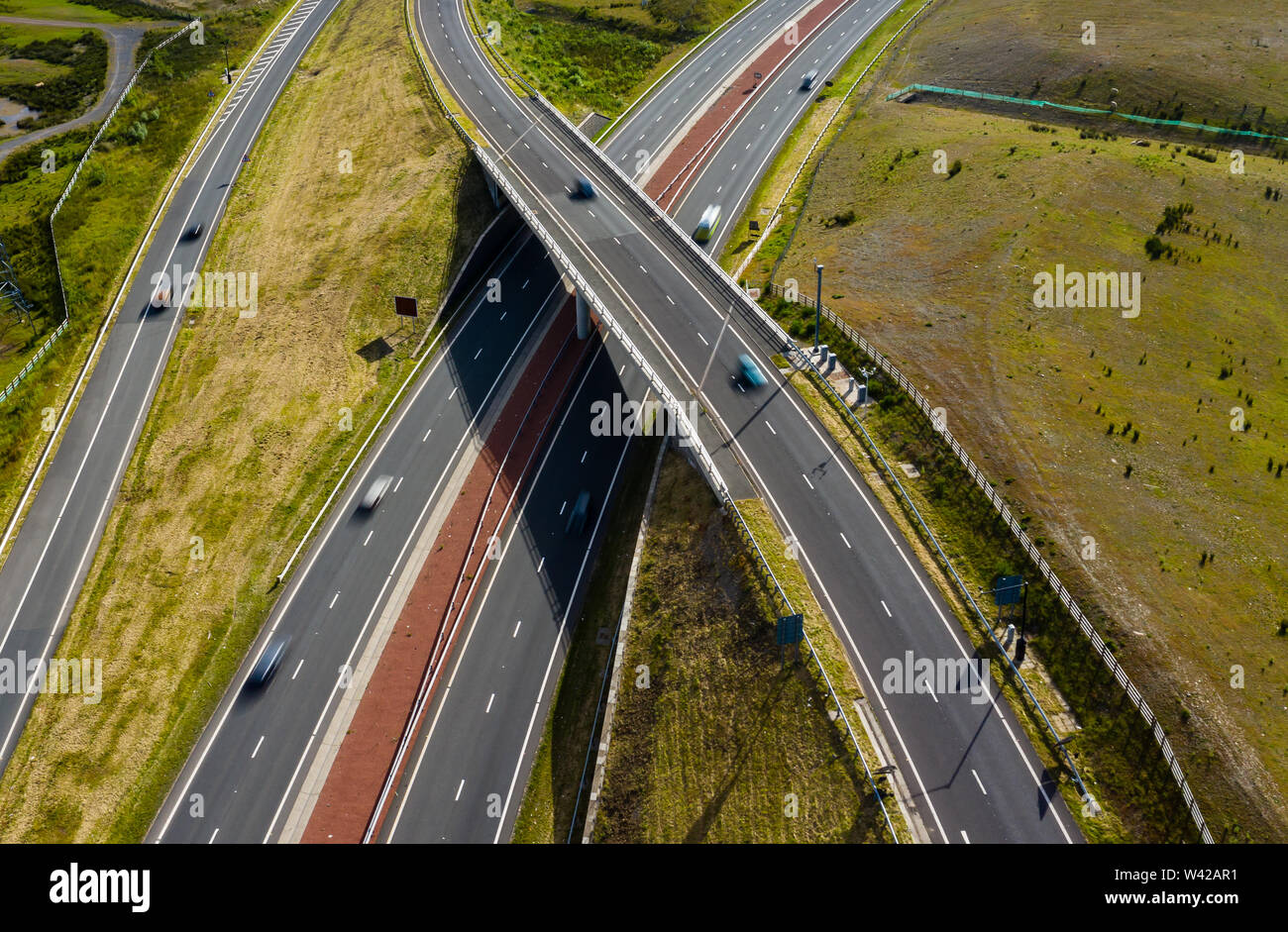 Aerial drone view of motion blurred traffic on a new, dual carriageway ...