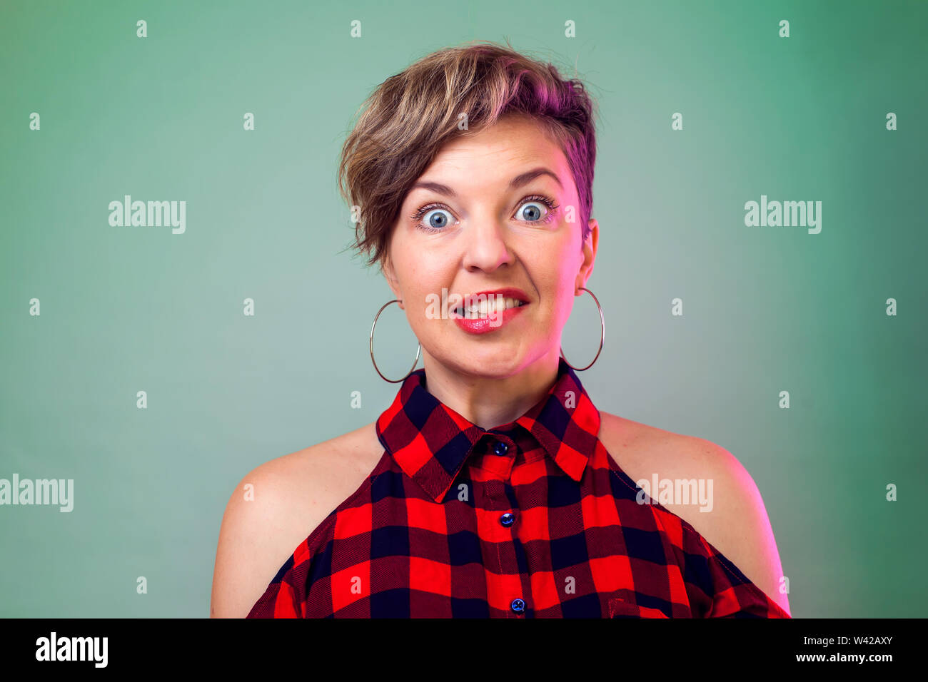 People and emotions -a portrait of young fearful woman with short hair ...