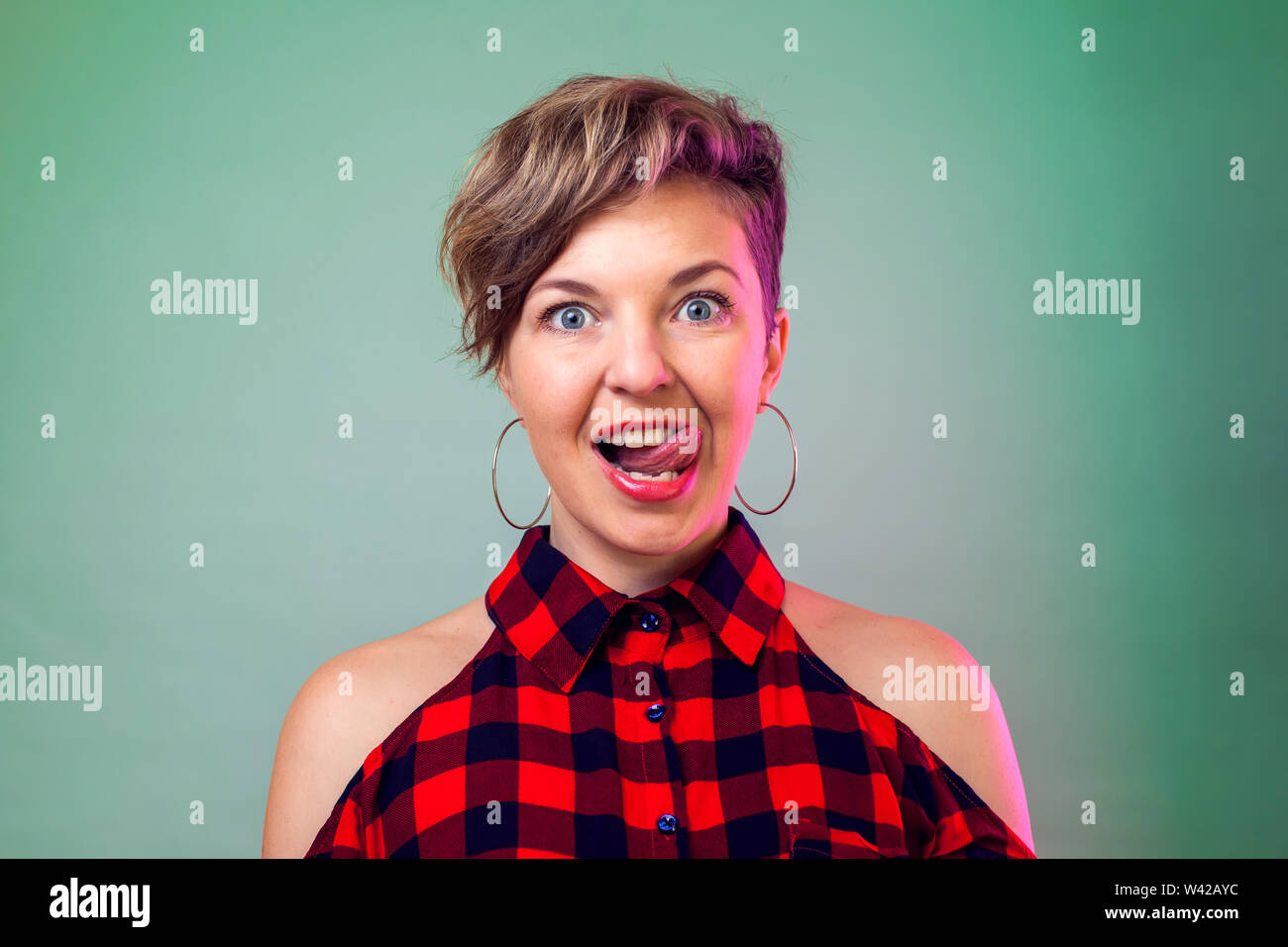 People and emotions - smiling young woman with short dark hair shows ...