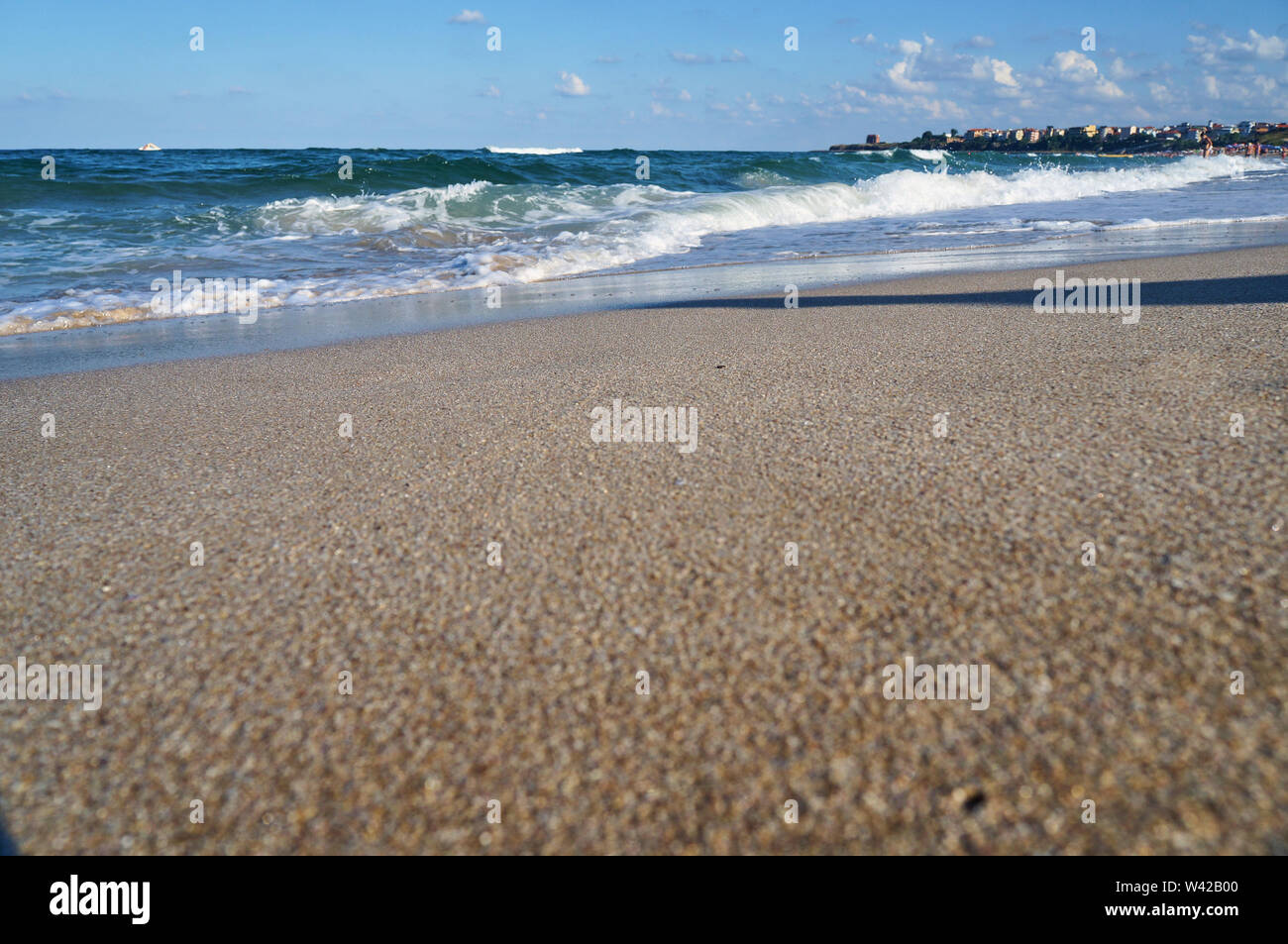 Surf and waves on the sandy shore of the Black Sea on a sunny summer ...