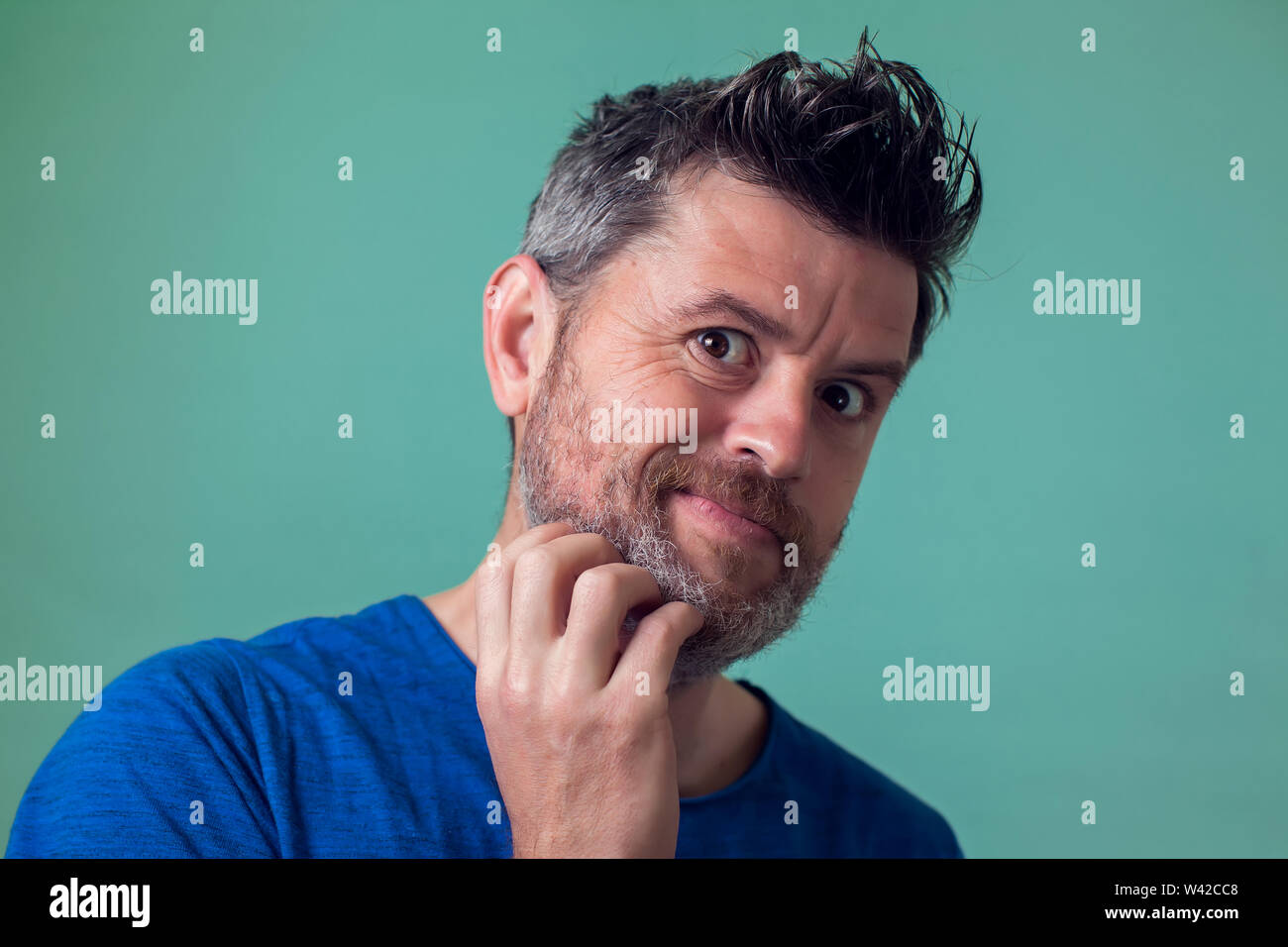 A man scratching his beard - people, healthcare and emotions Stock ...
