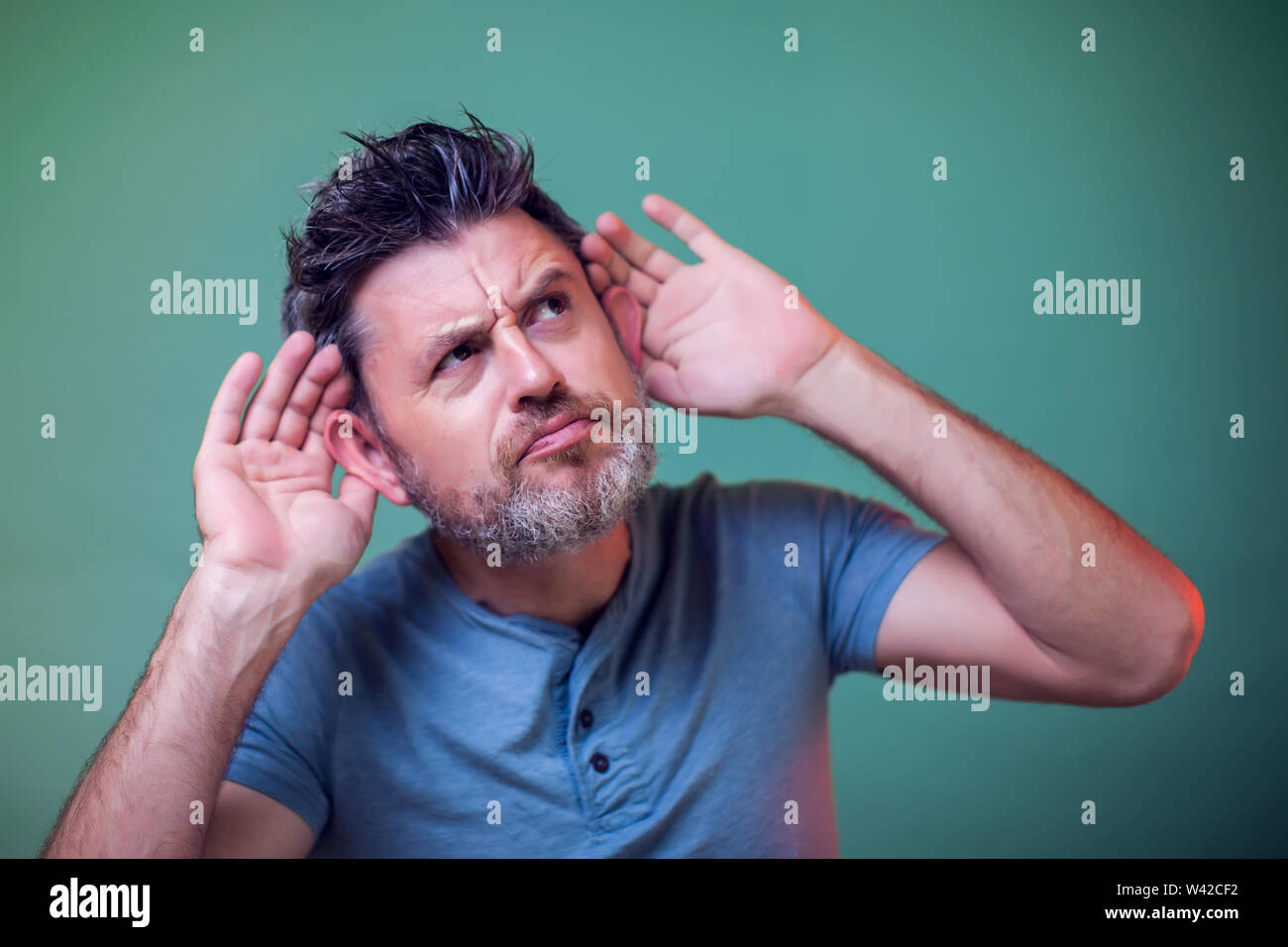People and emotions - a portrait of man with beard overhear something ...