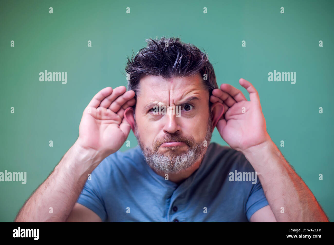 People and emotions - a portrait of man with beard overhear something ...