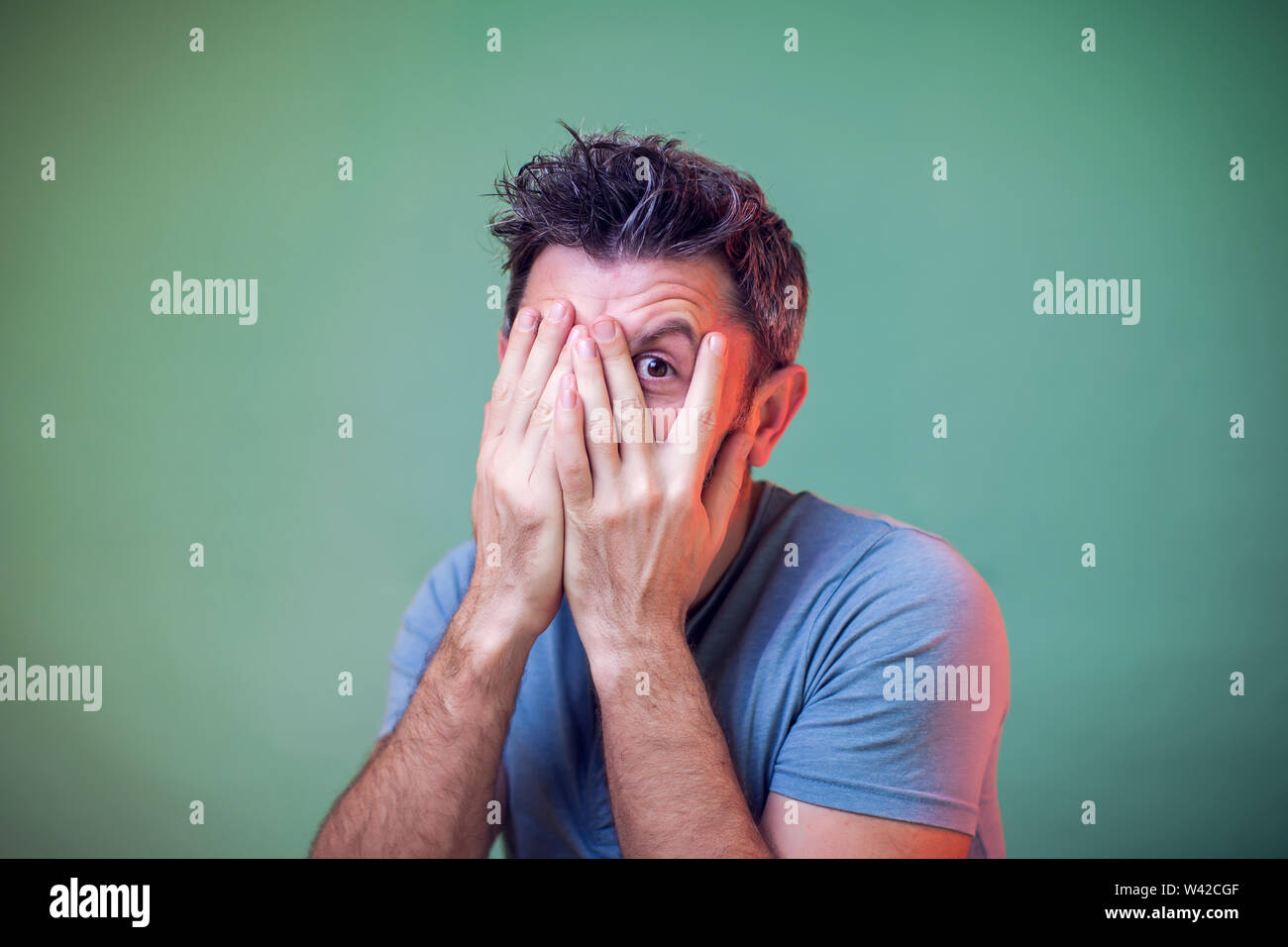 People and emotions - a portrait of man with beard scared of something ...