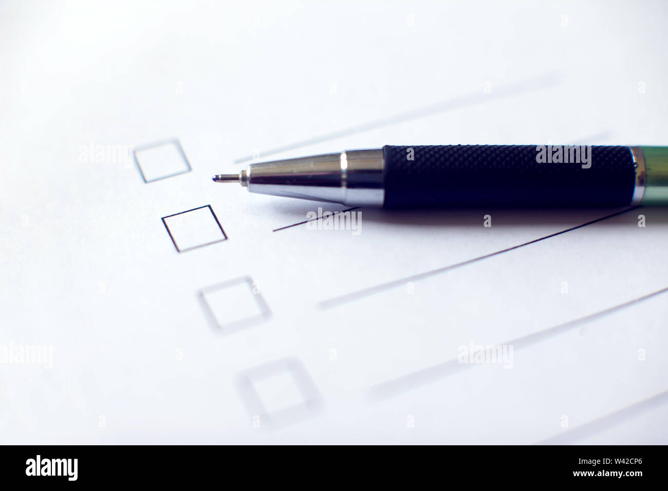 Checklist with a pen on white paper. Checkbox concept Stock Photo - Alamy