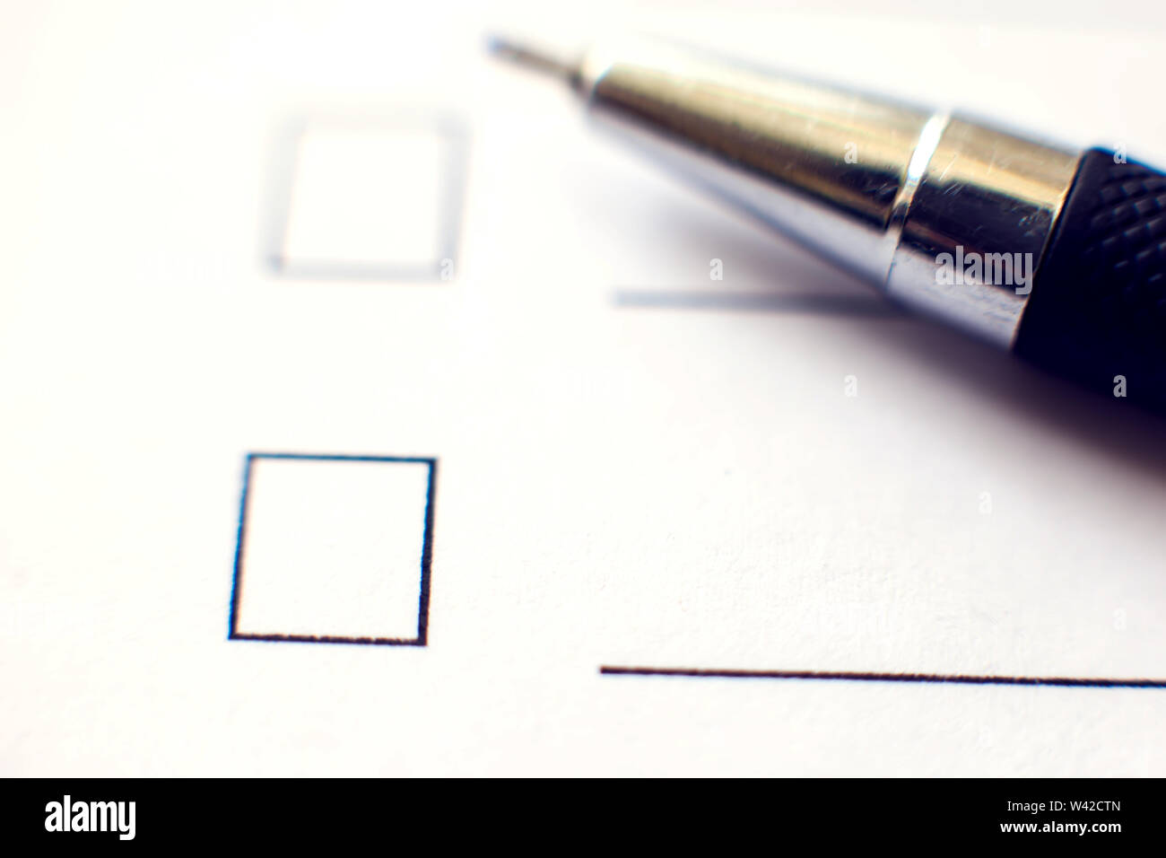 Checklist with a pen on white paper. Checkbox concept Stock Photo - Alamy